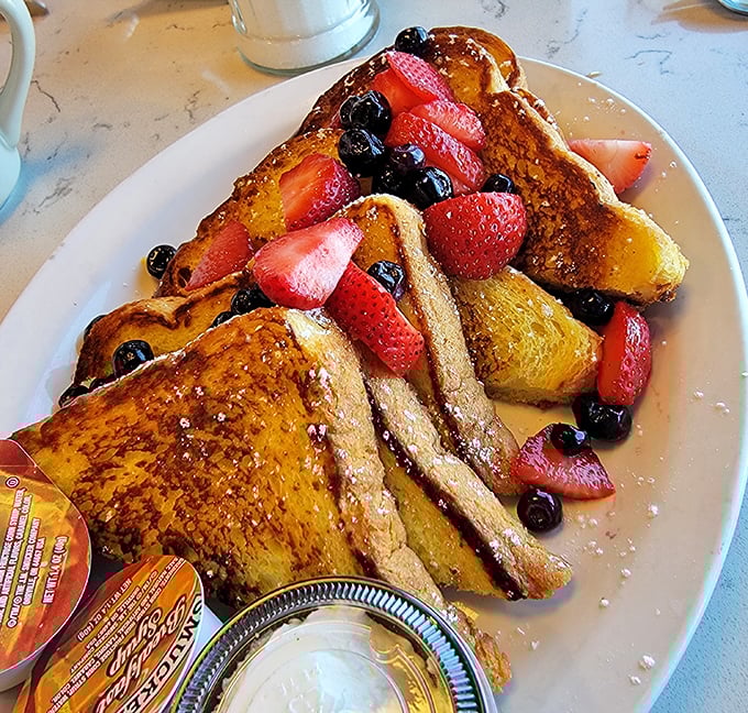 French toast that deserves its own Instagram account. Golden-brown perfection topped with berries so fresh they might have been picked this morning.