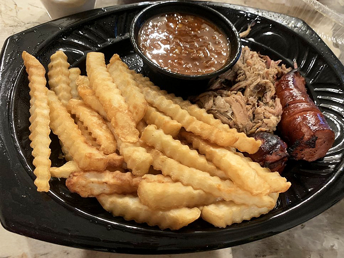 Those golden crinkle-cut fries aren't just a side &ndash; they're the perfect vehicle for sopping up that rich barbecue sauce and smoky meat juices.