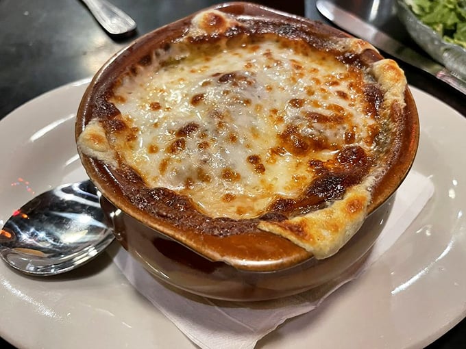 This isn't just French Onion Soup&mdash;it's a bubbling cauldron of comfort topped with a golden crown of melted cheese that stretches with each glorious spoonful.