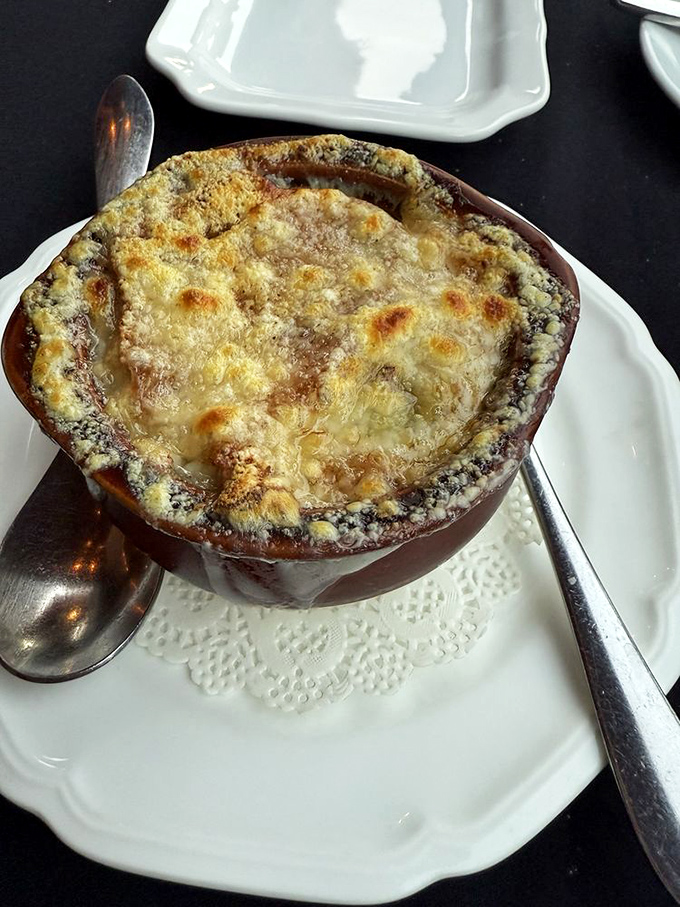 The legendary French onion soup arrives like a bubbling cauldron of cheese-topped heaven. Worth every mile of the drive.
