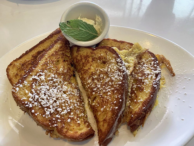French toast that Elvis would approve of. Golden-brown perfection dusted with powdered sugar and topped with a dollop of butter that's slowly melting into paradise.