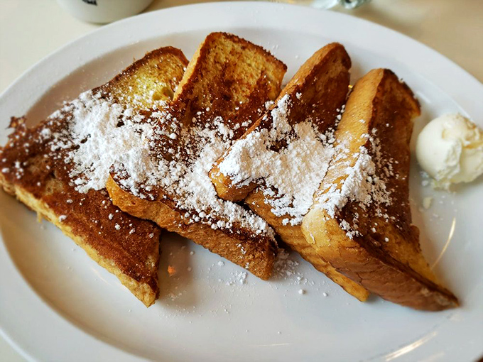 Golden-brown French toast dusted with powdered sugar&mdash;proof that sometimes the simplest pleasures are the most profound. That butter pat is just waiting for its maple syrup bath!
