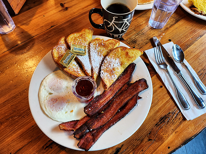 Golden-brown French toast dusted with powdered sugar alongside perfectly crisp bacon&mdash;breakfast's greatest hits album on a single plate.