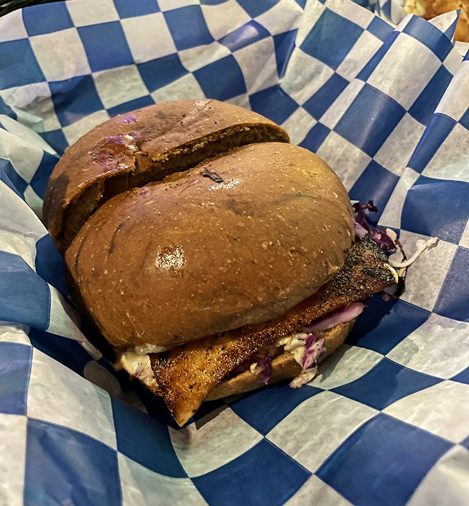 This isn't just a sandwich; it's a masterclass in seafood simplicity. The blackened mahi nestled in that bun has probably seen less travel time than your morning commute.