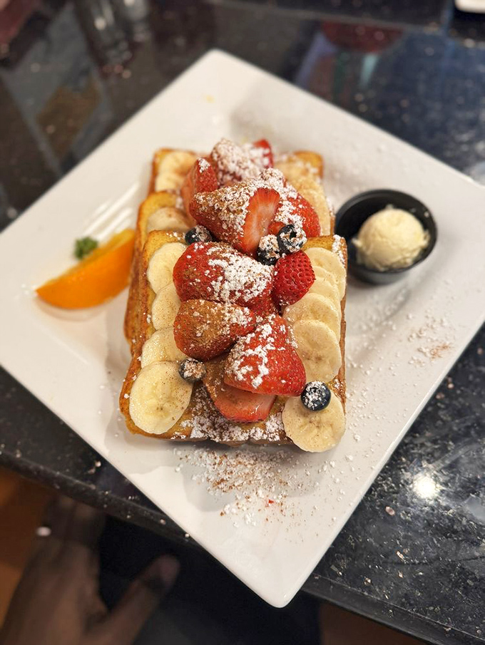 Fresh berries and bananas crown this French toast masterpiece like edible jewels on golden bread.