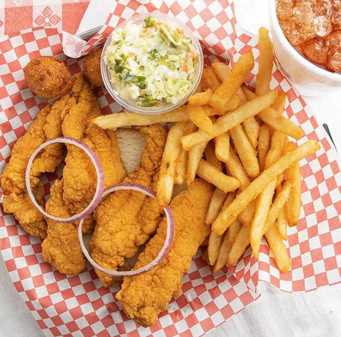 Golden-battered catfish strips that shatter with each bite, paired with crispy fries and coleslaw that cuts through the richness.