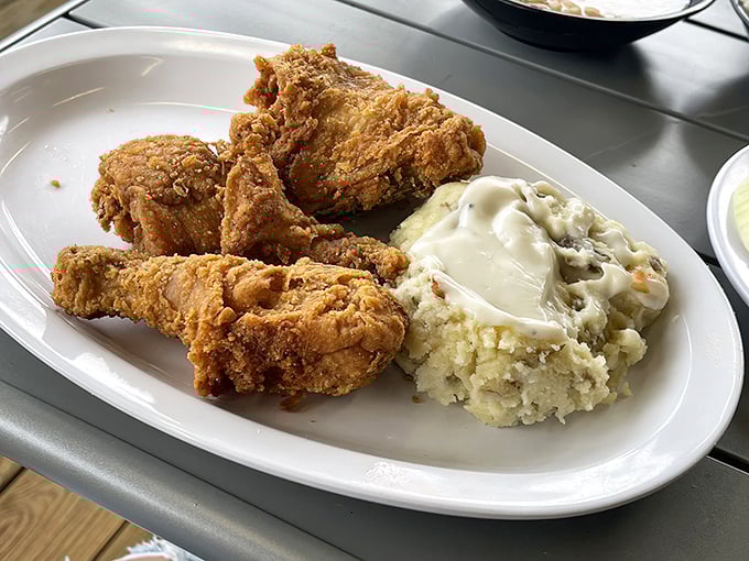 Golden-brown perfection that makes you question every other fried chicken you've encountered. The crispy exterior gives way to juicy meat that practically demands a moment of reverent silence.