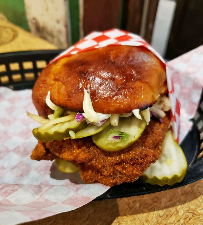 This isn't just a sandwich; it's an architectural masterpiece of crispy chicken, tangy pickles, and slaw, all nestled in a bun that deserves its own fan club.