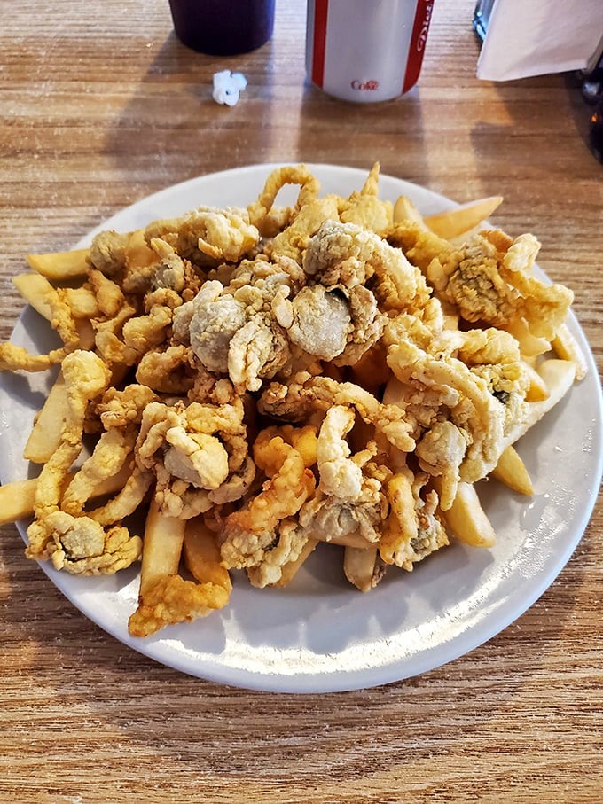 Golden-fried clam strips piled high atop crispy fries&mdash;a mountain of seafood goodness that would make Neptune himself weep with joy.