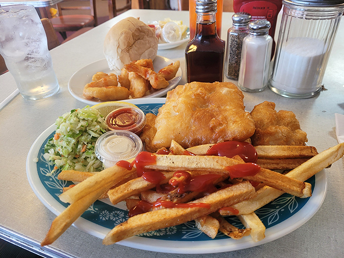 Golden-battered cod that shatters at first bite, paired with crispy fries and creamy coleslaw&mdash;the holy trinity of comfort food done absolutely right.