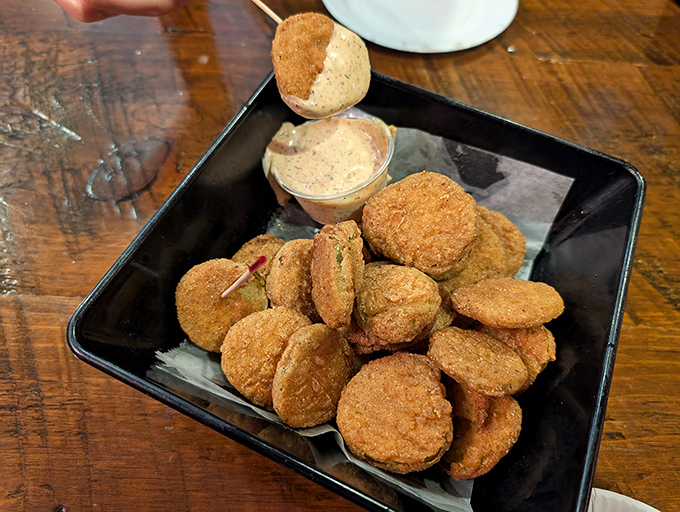 These golden-fried pickles aren't just appetizers—they're the opening act for the main event, a crunchy prelude to the burger symphony to come.