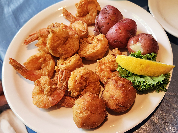 Golden-fried shrimp that crunch like nature's perfect potato chip, paired with red potatoes that somehow make you forget French fries exist.