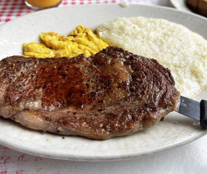 That perfectly seasoned steak isn't just breakfast&mdash;it's performance art with protein. The grits and eggs are just supporting actors in this delicious drama.
