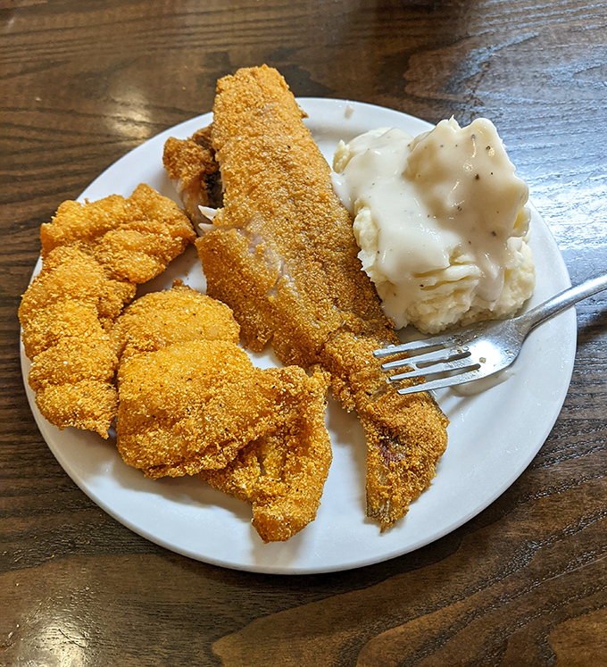Behold the star: fried catfish so perfectly golden it practically glows with Southern pride.