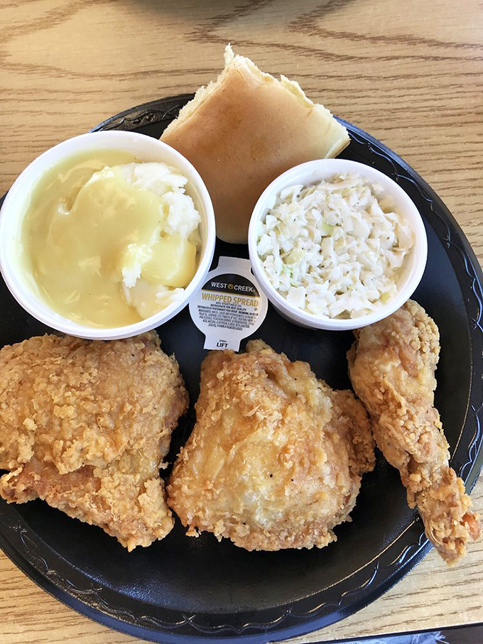 The holy trinity of Southern comfort: golden-crisp chicken, creamy mashed potatoes, and coleslaw that actually deserves its place on the plate.