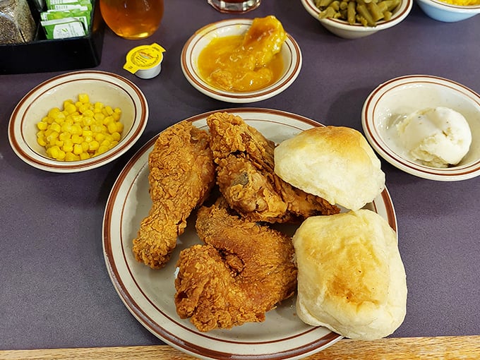 Golden-brown fried chicken that makes Colonel Sanders weep with jealousy, paired with fluffy rolls that deserve their own fan club.