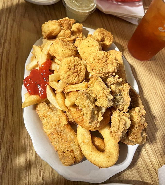 Golden-fried perfection that would make Neptune himself weep. This seafood platter delivers crispy treasures alongside french fries destined for ketchup baptism. 