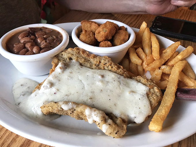Country fried steak that's practically performing a balancing act on the plate. That pepper gravy doesn't just cover the meat&mdash;it completes it.