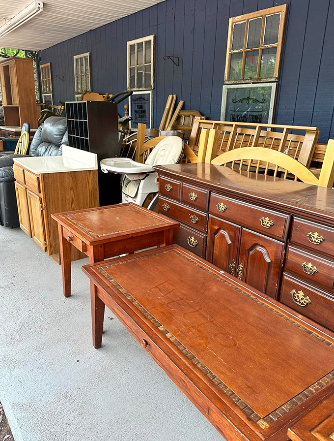 Solid wood furniture with personality lines the outdoor display area. That mahogany dresser has witnessed more family dinners than your holiday tablecloth.