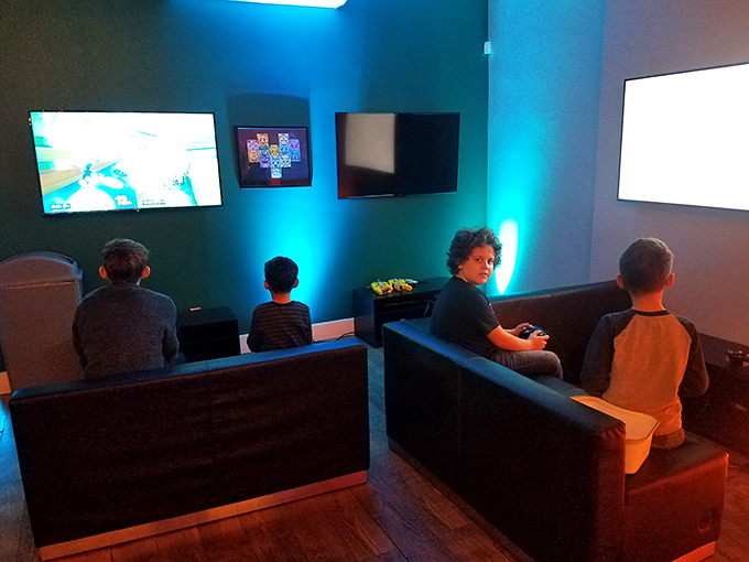 Modern comforts meet retro challenges in this gaming lounge where kids discover what "game over" really means when quarters aren't infinite.