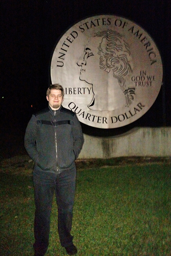 Even after sunset, this colossal coin commands attention. Night lighting transforms Washington's profile into a dramatic silhouette against the evening sky.