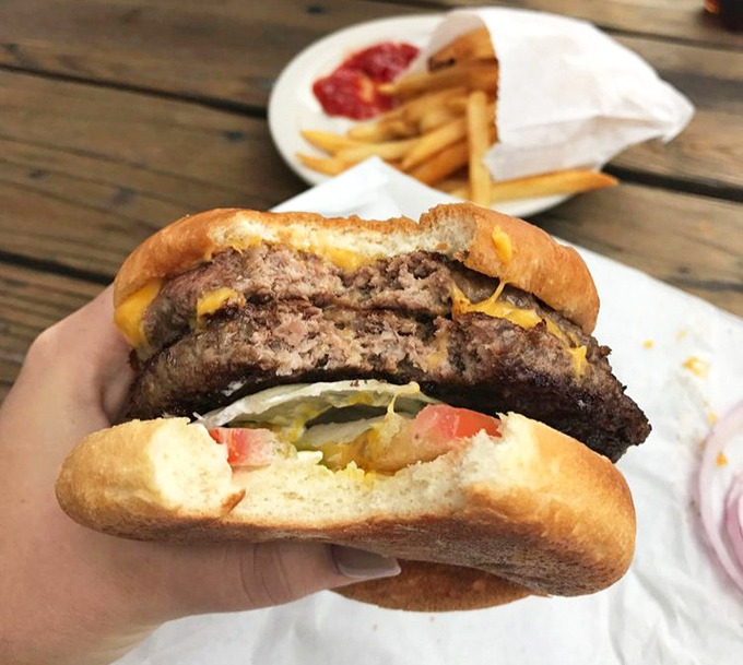 Behold the architectural marvel that is the Giant Cheeseburger. That perfect cross-section reveals juicy patties that laugh in the face of diet plans.