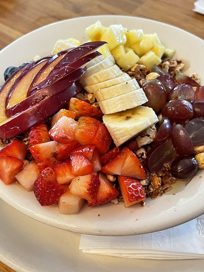 Breakfast artistry in a bowl: house-made granola crowned with a rainbow of fresh fruit that makes you momentarily forget donuts exist.