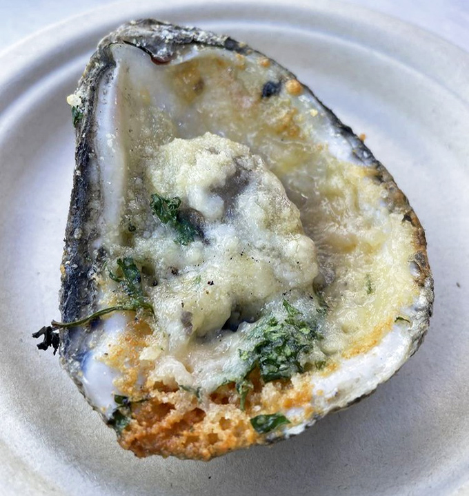 Butter, garlic, and a hint of herbs transform this oyster into edible poetry. The perfect char marks are like nature's signature on a masterpiece.