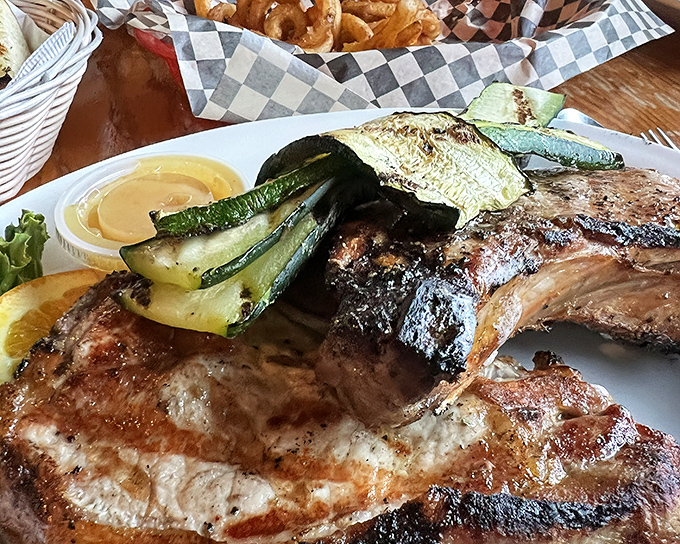 These pork chops have clearly been introduced to fire and seasoning by someone who understands the sacred relationship between meat and flame.