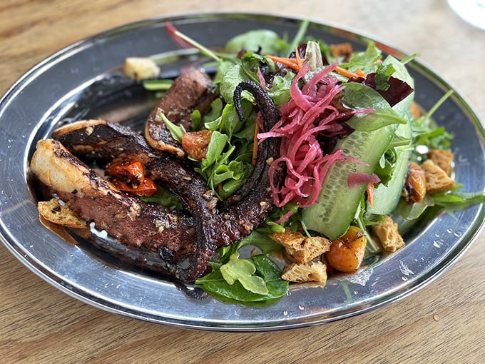 The legendary grilled octopus arrives like an edible work of art, with tentacles so tender they practically surrender to your fork.