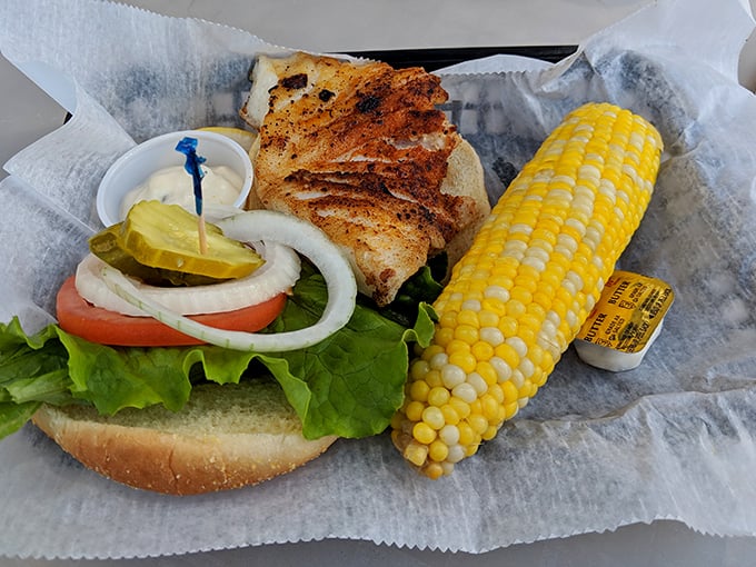 Not just a sandwich, but a monument to Florida's seafood heritage. This grouper masterpiece with sweet corn on the side is summer on a plate.