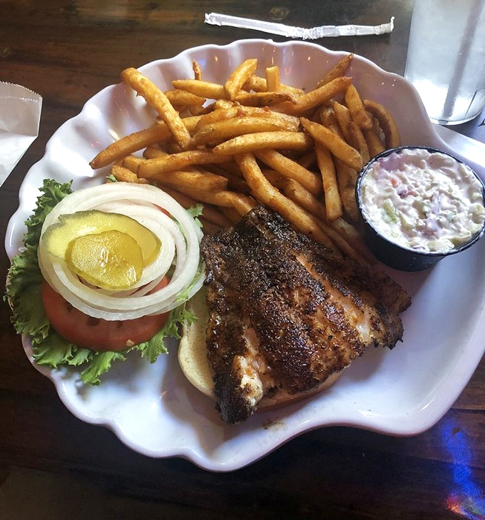 The legendary grouper sandwich in its natural habitat. Golden-fried perfection with crispy fries and that essential side of slaw.
