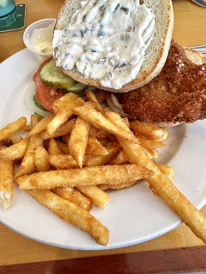 The star of the show: Shuckers' grouper sandwich with golden fries. One bite and you'll understand why Floridians guard their favorite fish spots like treasure maps.
