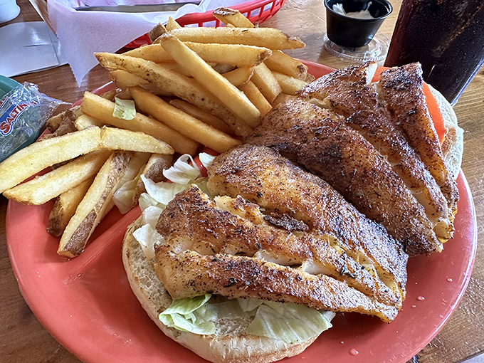 This blackened grouper sandwich isn't just hanging off the bun&mdash;it's making a statement. The fish-to-bread ratio here is what mathematicians call "the golden proportion."