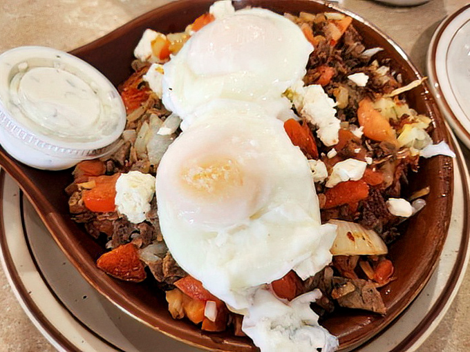 This hearty skillet doesn't just feed you—it hugs you from the inside. Two perfectly cooked eggs crown a mountain of savory ingredients like royal jewels.