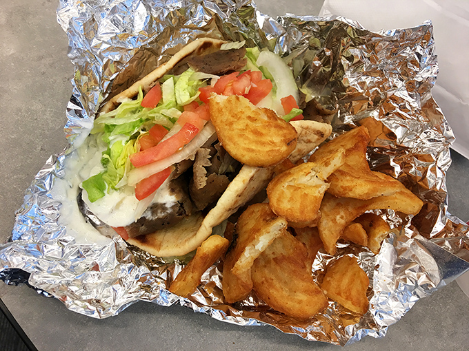 This isn't just a gyro, it's an edible work of art &ndash; perfectly crisp potatoes nestled beside a foil-wrapped package of Mediterranean bliss.