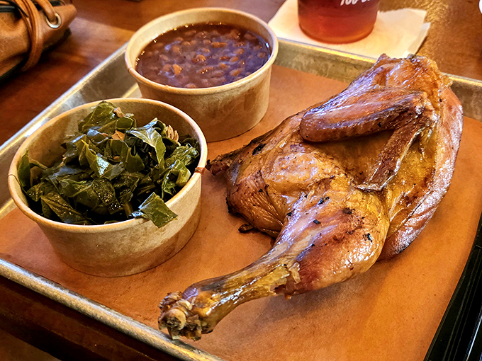 Half a chicken that's had a proper introduction to smoke. Those collard greens and beans aren't just sides&mdash;they're supporting actors in a delicious drama.