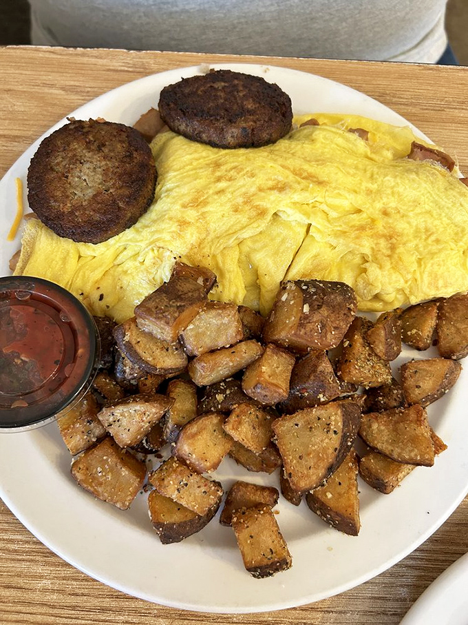 Behold the ham and cheese omelet: fluffy eggs embracing savory filling like a warm, delicious hug on a plate.