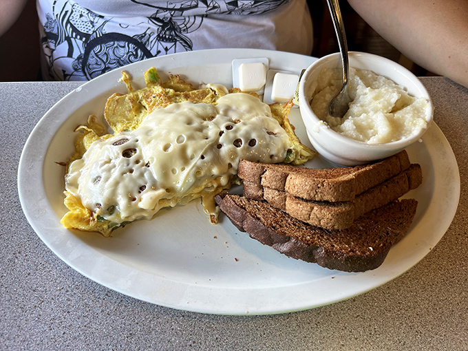 Behold the star attraction: a ham and cheese omelet that's achieved perfect harmony. The melted cheese blankets the eggs like a cozy comforter on a Sunday morning.