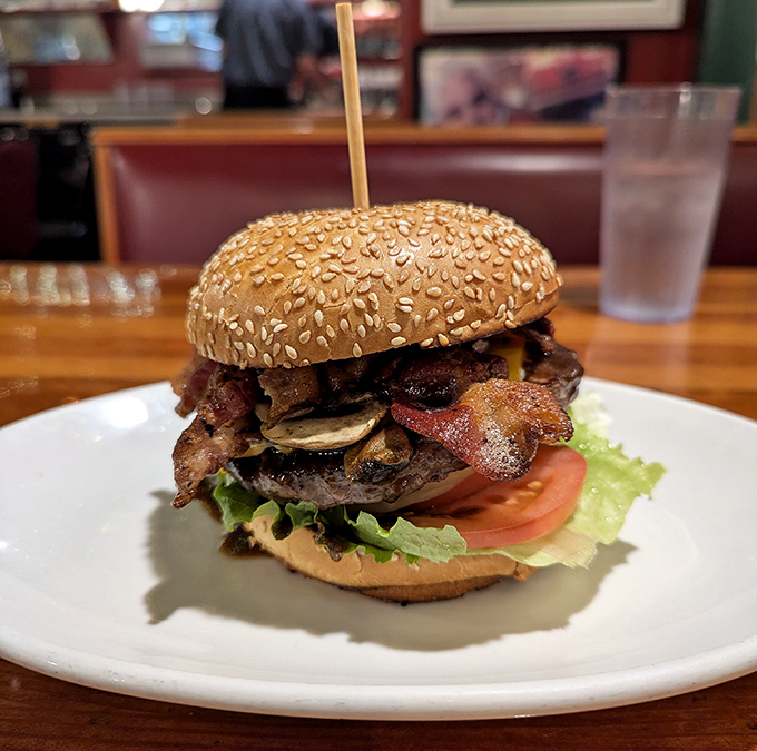 This isn't just a burger&mdash;it's an architectural marvel of beef, bacon, mushrooms, and fresh veggies that requires both hands and possibly a strategy session.
