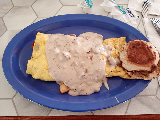 Behold the Hillbilly omelet, draped in country gravy like a comforting blanket on a chilly morning. This isn't just breakfast—it's edible therapy for whatever ails you.