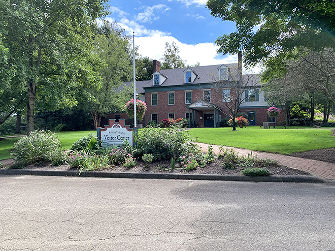 The Coshocton Visitor Center welcomes travelers with brick-and-mortar hospitality, surrounded by gardens that say "stay awhile" without saying a word.