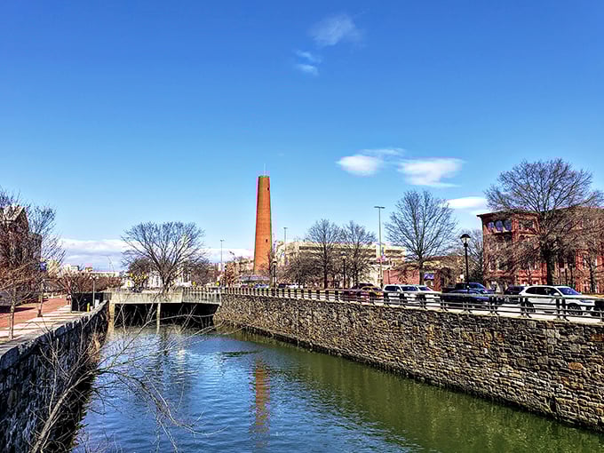 Where industrial history meets urban waterway. The tower stands sentinel over Jones Falls like a brick lighthouse guiding ships through waves of concrete and commerce.