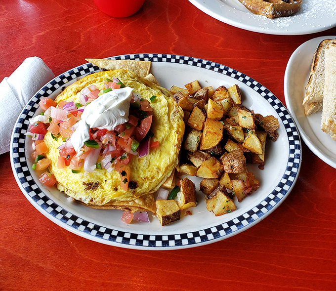 Breakfast nirvana on a checkered plate. Those home fries aren't just cooked&mdash;they're persuaded into golden-brown perfection through patience and garlic.