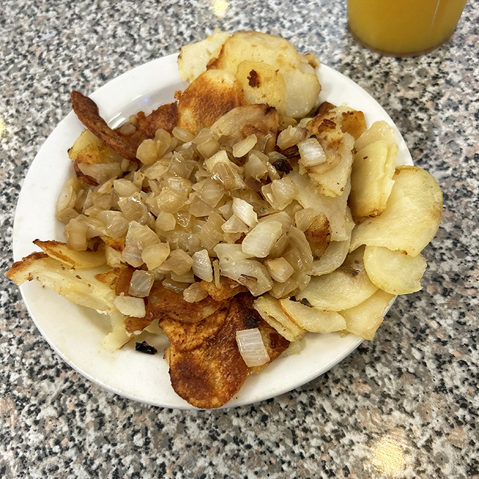 These aren't just home fries &ndash; they're a masterclass in potato perfection, with saut&eacute;ed onions creating a symphony of flavor in every bite.