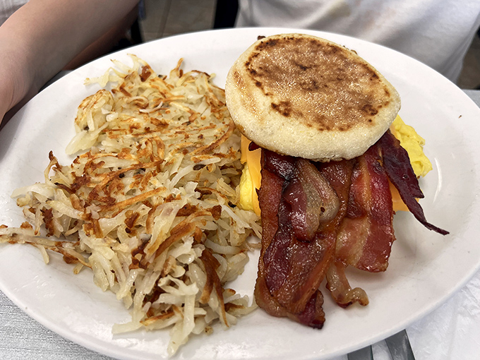 Breakfast engineering at its finest! Crispy hash browns, perfectly cooked eggs, and bacon that deserves its own theme song, all on one glorious plate.