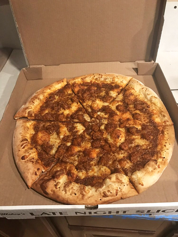 This isn't just a pizza&mdash;it's a commitment. The meaty masterpiece sits in its cardboard throne, practically daring you to finish it.