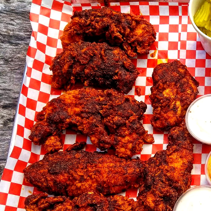 This isn't just chicken; it's a crimson-coated flavor bomb that makes taste buds simultaneously celebrate and surrender. The classic presentation on checkered paper says "prepare for delicious trouble."
