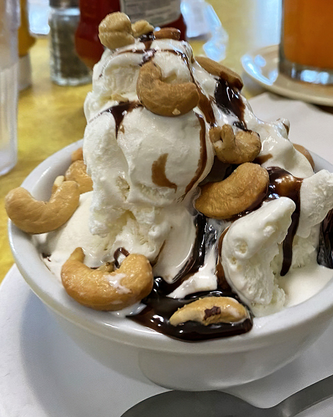 Ice cream architecture at its finest. Those cashews aren't just toppings&mdash;they're the crown jewels in a kingdom of vanilla and hot fudge. 