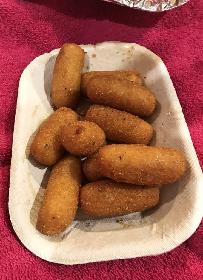 Golden-brown hush puppies that could make a cardiologist weep with both joy and professional concern.